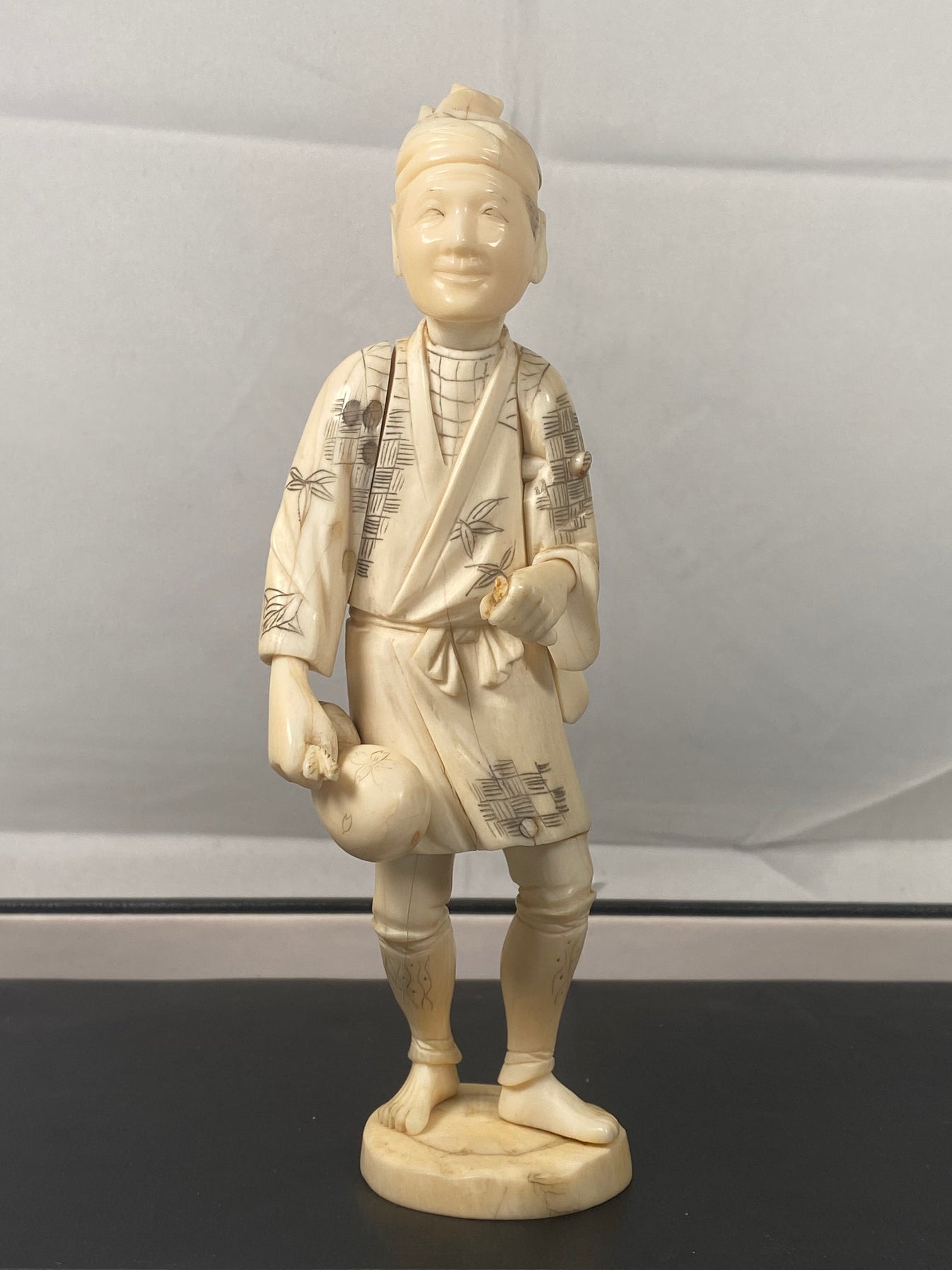 Signed Tokyo School Japanese ivory okimono of a man holding calabash ...